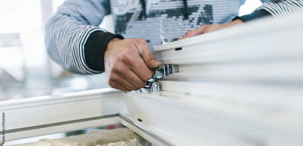 Manual worker assembling PVC doors and windows. Manufacturing jobs ...