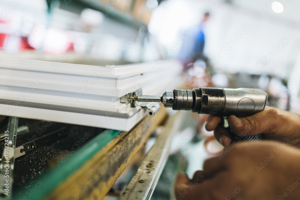 Manual worker assembling PVC doors and windows. Manufacturing jobs ...