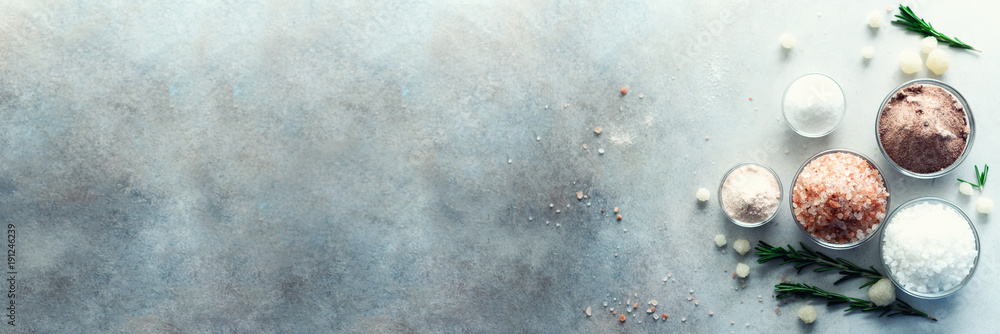 Mix of different salt types on grey concrete background. Sea salts ...