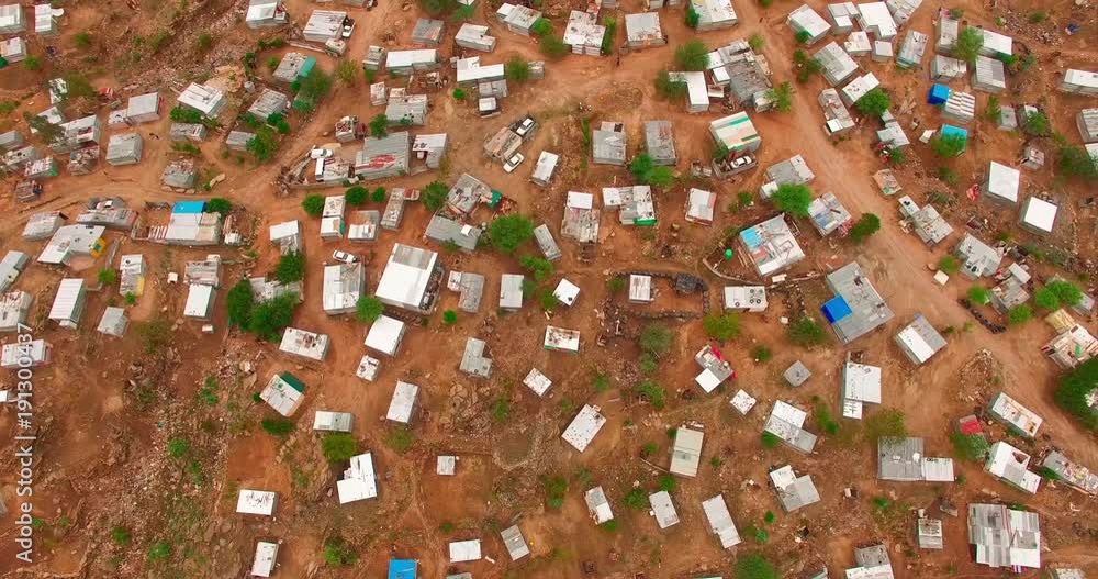 Vidéo Stock A bird's-eye view taken over a city with ruined houses in ...