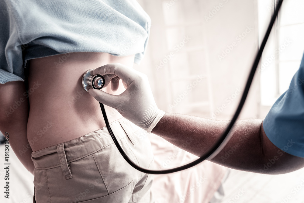 Everyday medical routine. Scaled up look on a male medical worker in ...