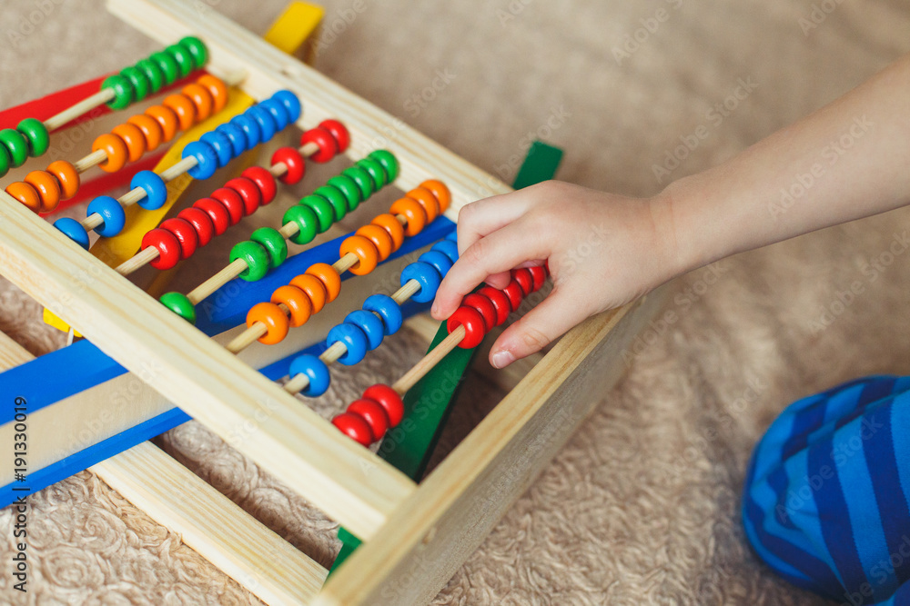 Preschooler baby learns to count. Cute child playing with abacus toy ...