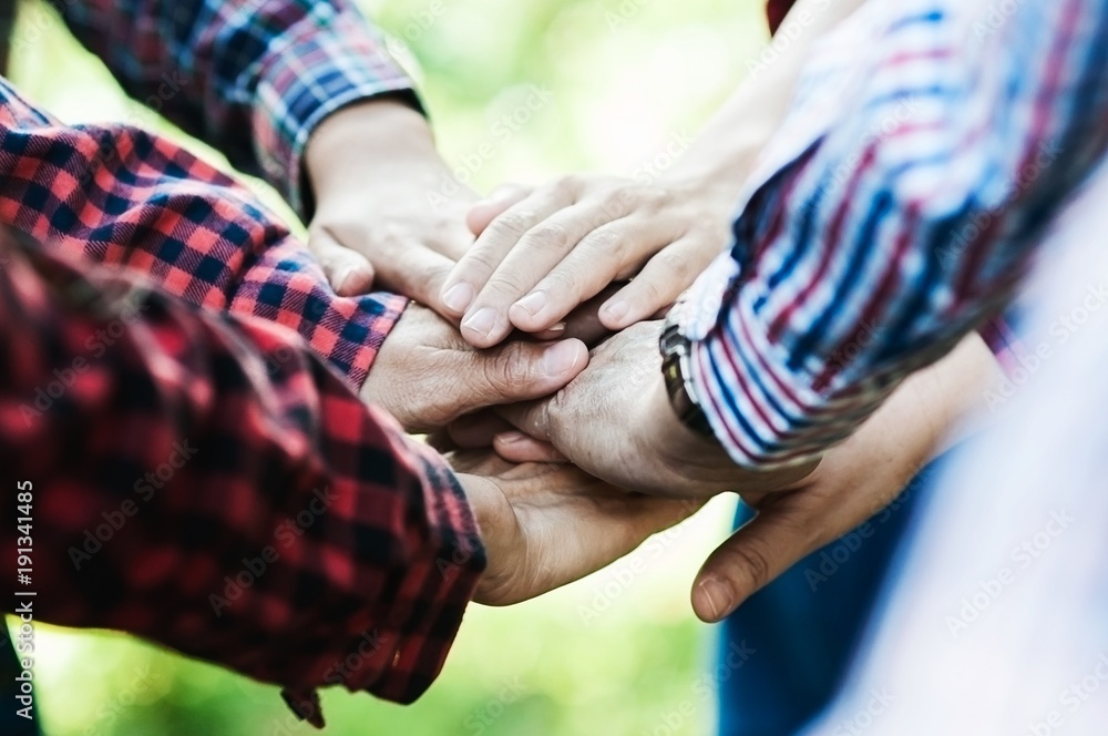 People group join hands together as teamwork unity symbol during their ...