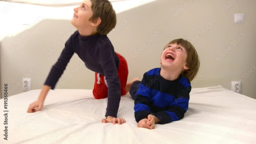 Cute happy kids playing in bed, parents dropping sheet over them Stock ...