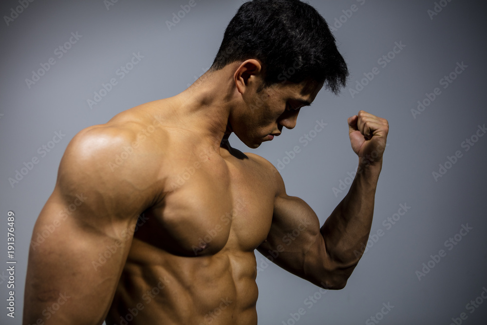 Fitness Model Flexing Bicep Muscle Stock Photo | Adobe Stock