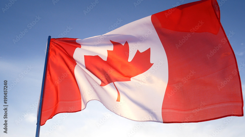 Canada flag on clear blue sky Stock Photo | Adobe Stock