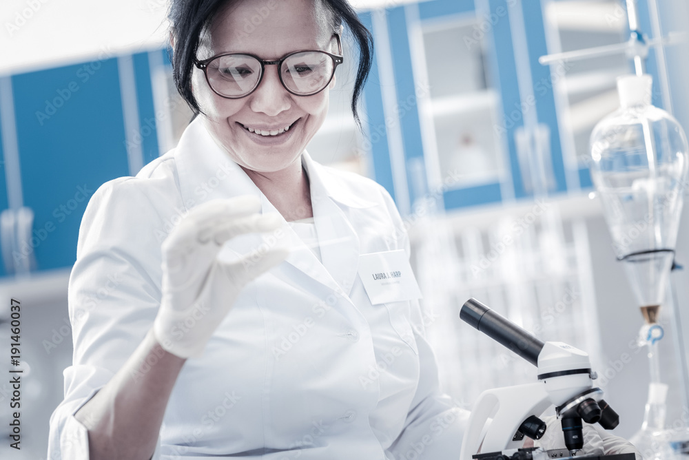 Looks promising. Low angle shot of a satisfied female researcher ...