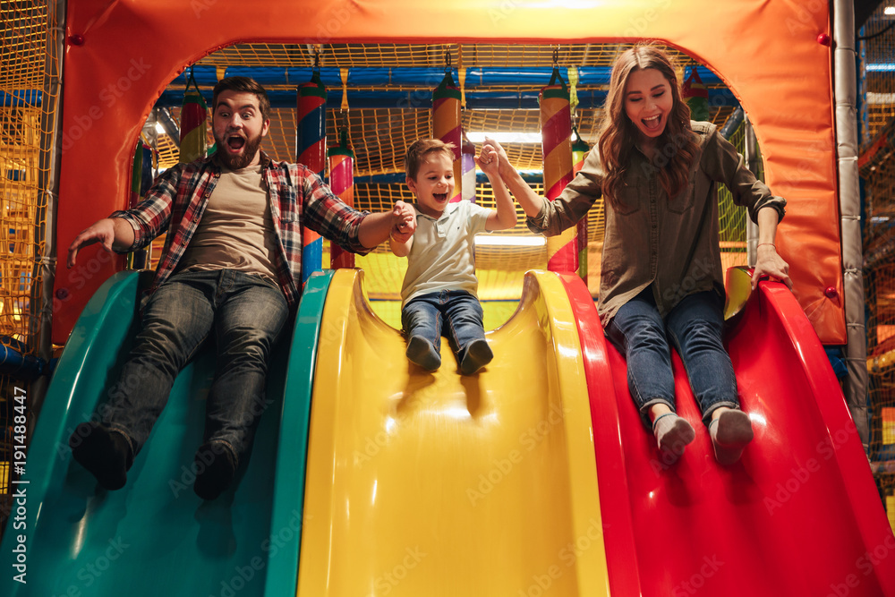 Happy little boy playing on a slide Stock Photo | Adobe Stock