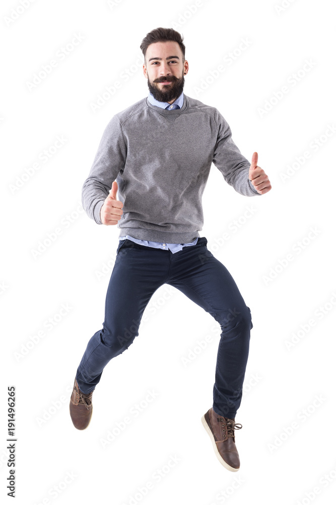 Joyful excited business man jumping with thumbs up gesture smiling at ...