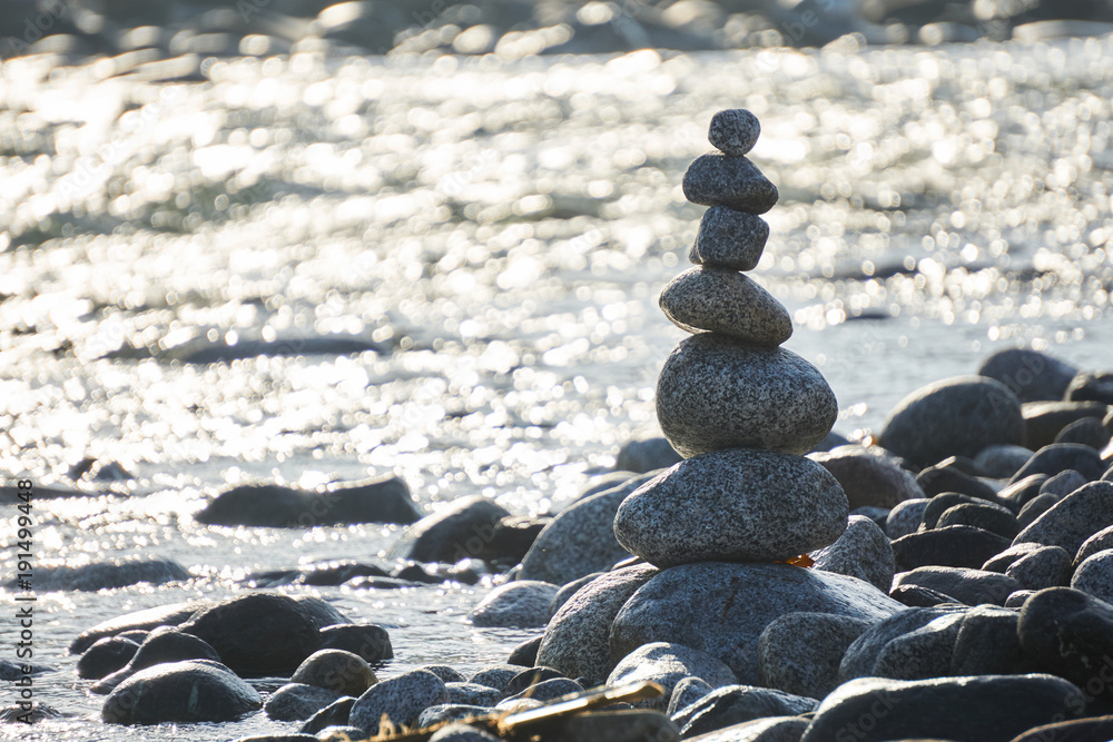 Stack of pebble stones over bokeh background. Concept zen, spa, summer ...