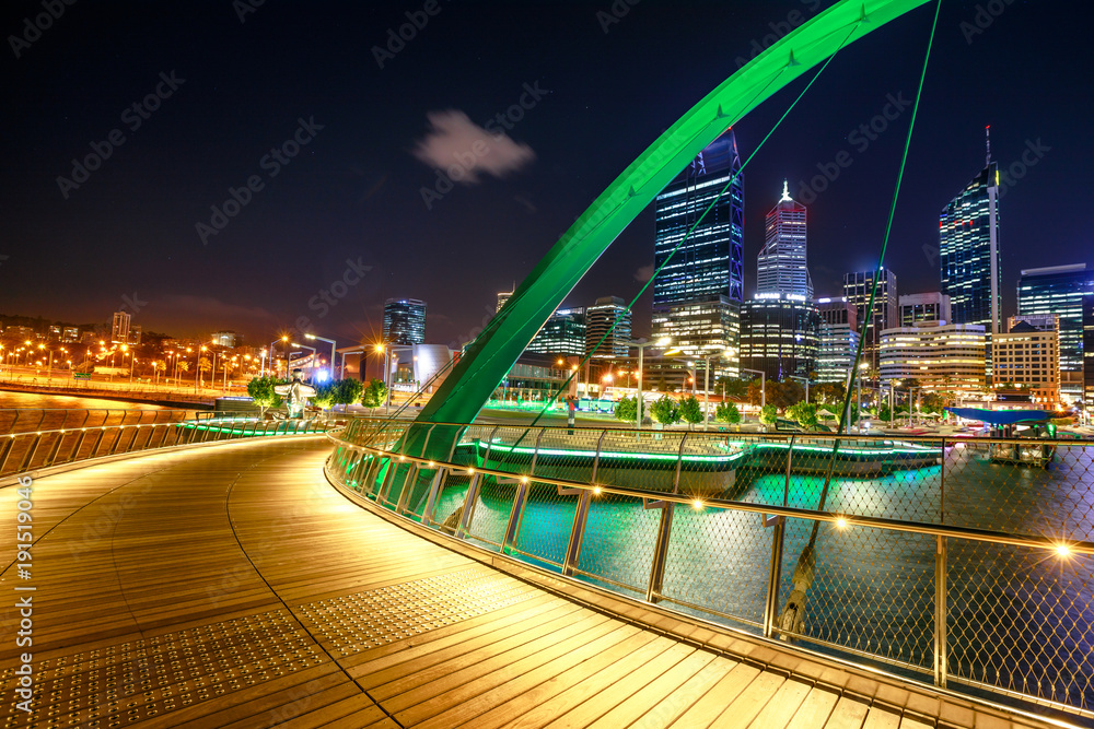 Wooden footpath of Elizabeth Quay Bridge illuminated by night at ...