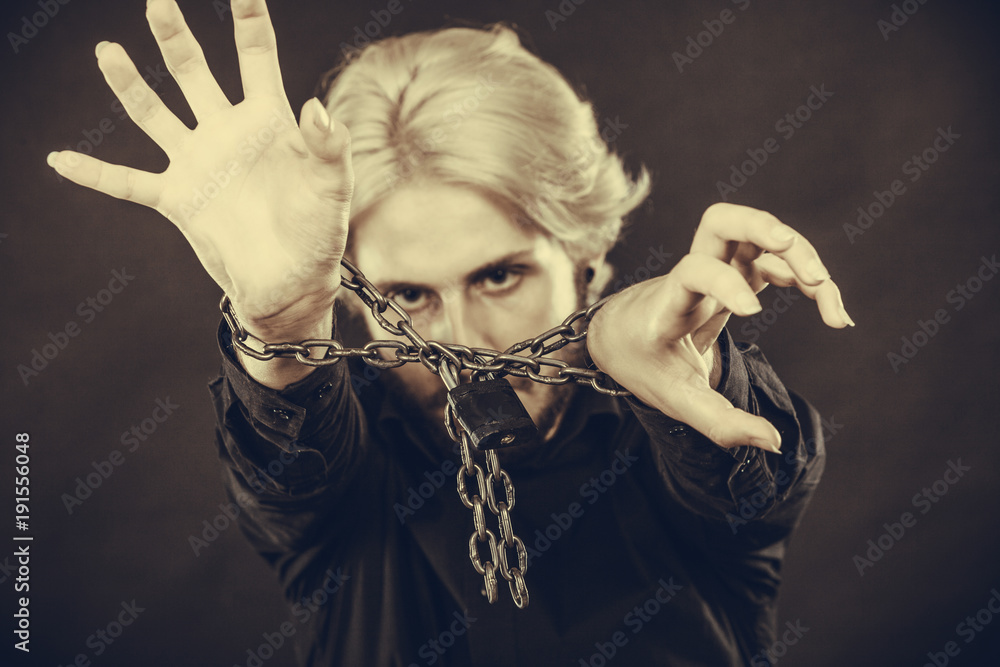 Foto Stock Scared man with chained hands, no freedom | Adobe Stock