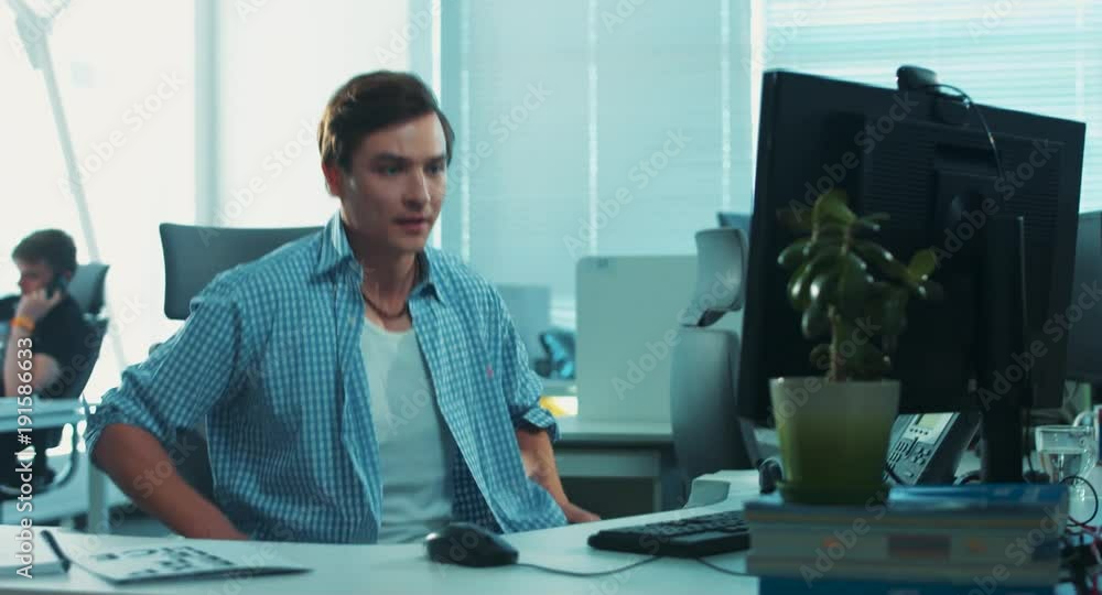 Rested and ready-to-work guy coming to work after weekend. Computer ...