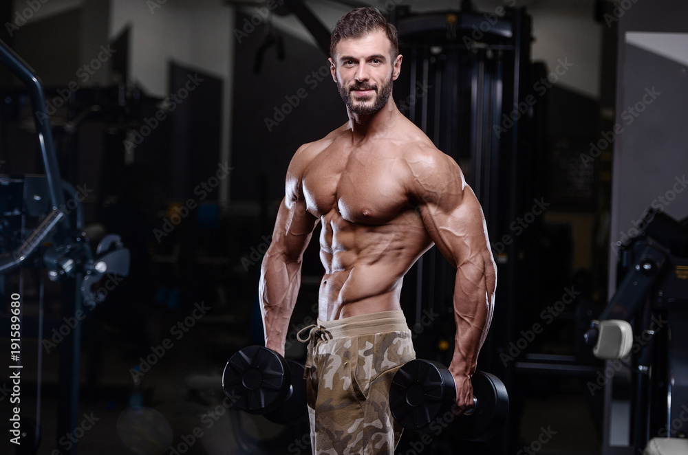 sexy strong bodybuilder athletic men pumping up muscles with dumbbells ...