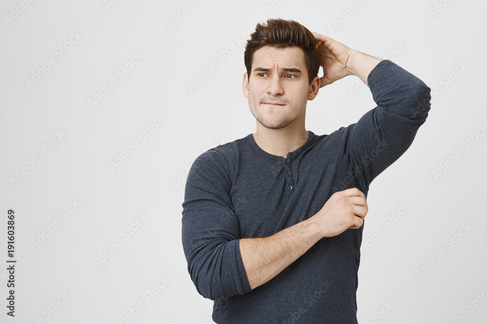 Indoor shot of thoughtful attractive man with trendy haircut and ...