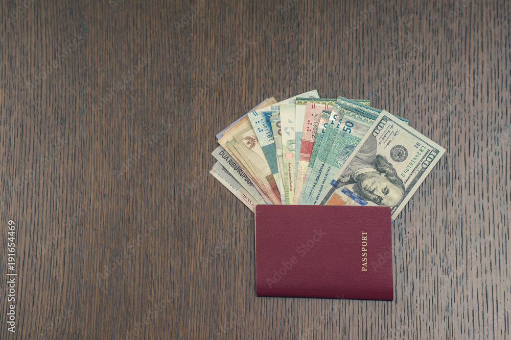 Foreign passport with money of south-east Asia and American hundred ...