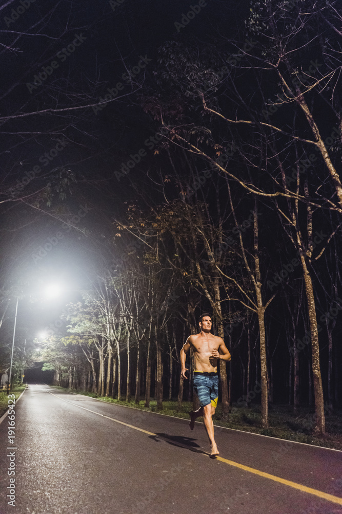 Shirtless man running on road Stock Photo | Adobe Stock