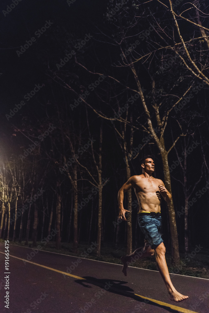 Shirtless man running on road Stock Photo | Adobe Stock