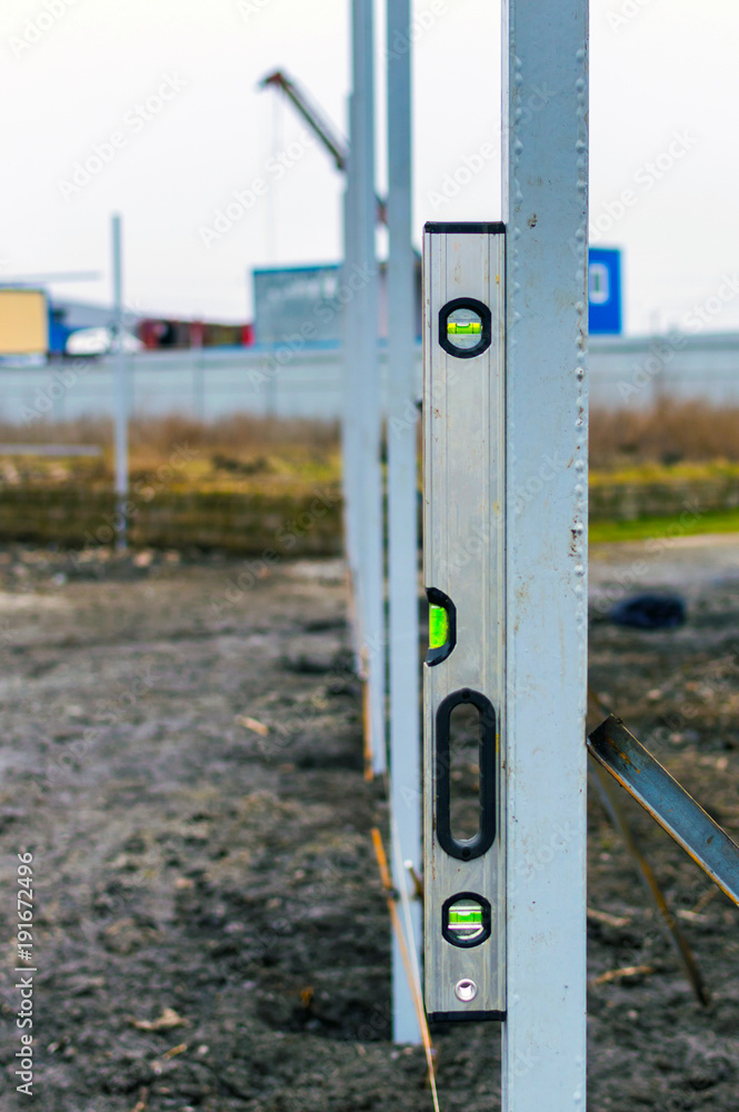 Magnet water bubble level gauge on steel beam at construction site for ...