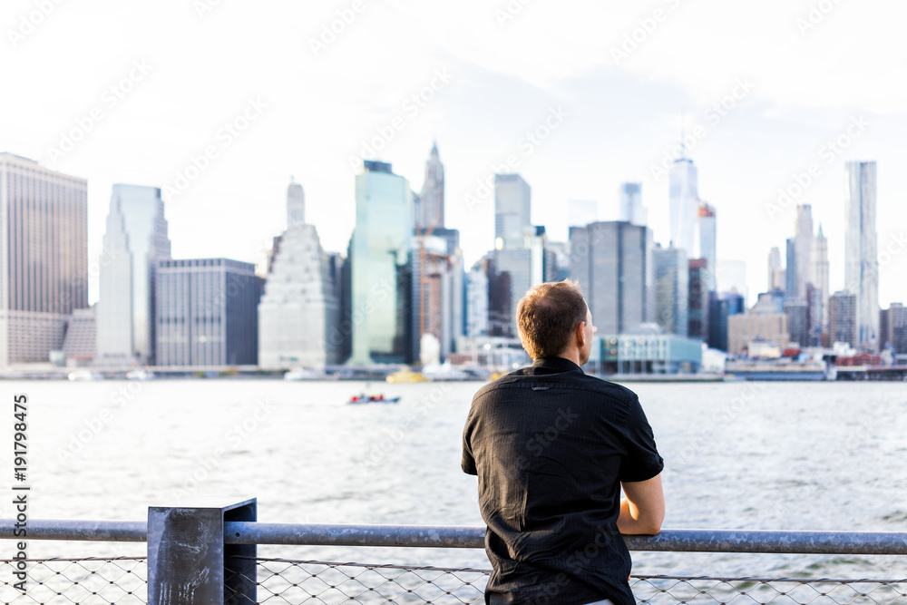 Back of young man outside outdoors in NYC New York City Brooklyn Bridge ...
