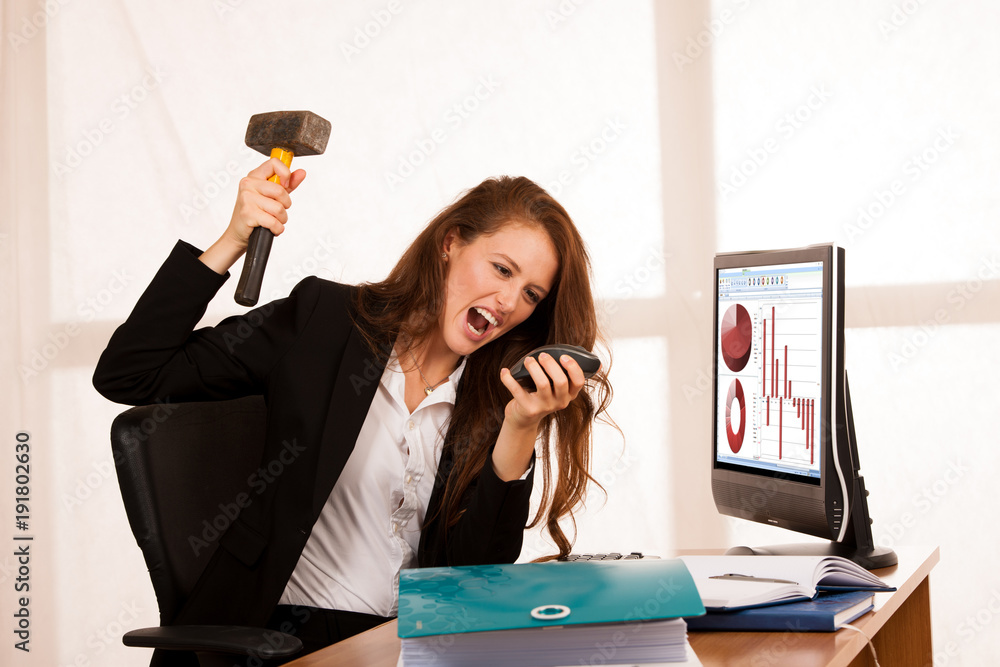 Angry business woman expressing rage at her desk in the office Stock ...