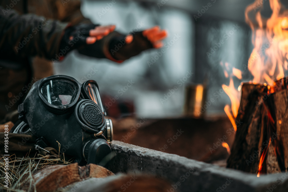 Stalker, male person warms his hands on fire Stock Photo | Adobe Stock