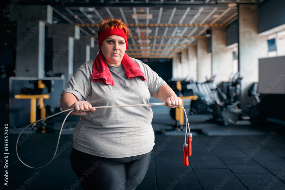 Fat sweaty woman, fitness exercise with rope Stock Photo | Adobe Stock