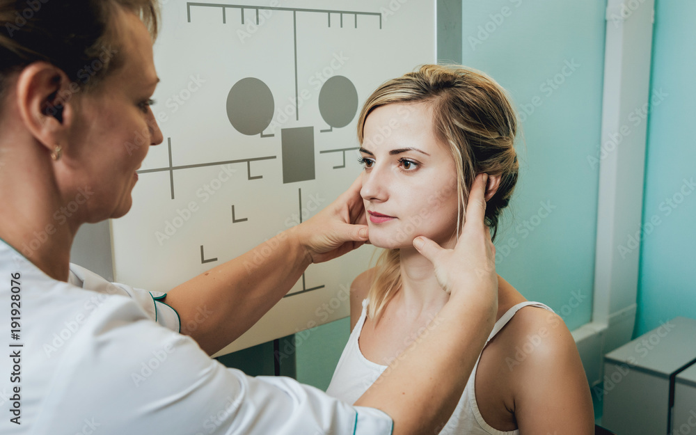 Radiologist and patient in a x-ray room. Classic ceiling-mounted x-ray ...