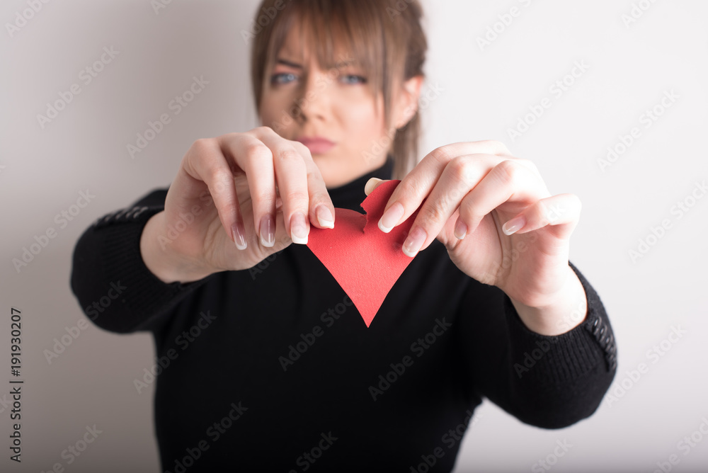 woman tearing up heart Stock Photo | Adobe Stock