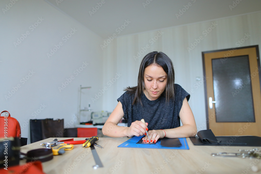 Female showing how to make stylish leather purse, blogger interested in ...