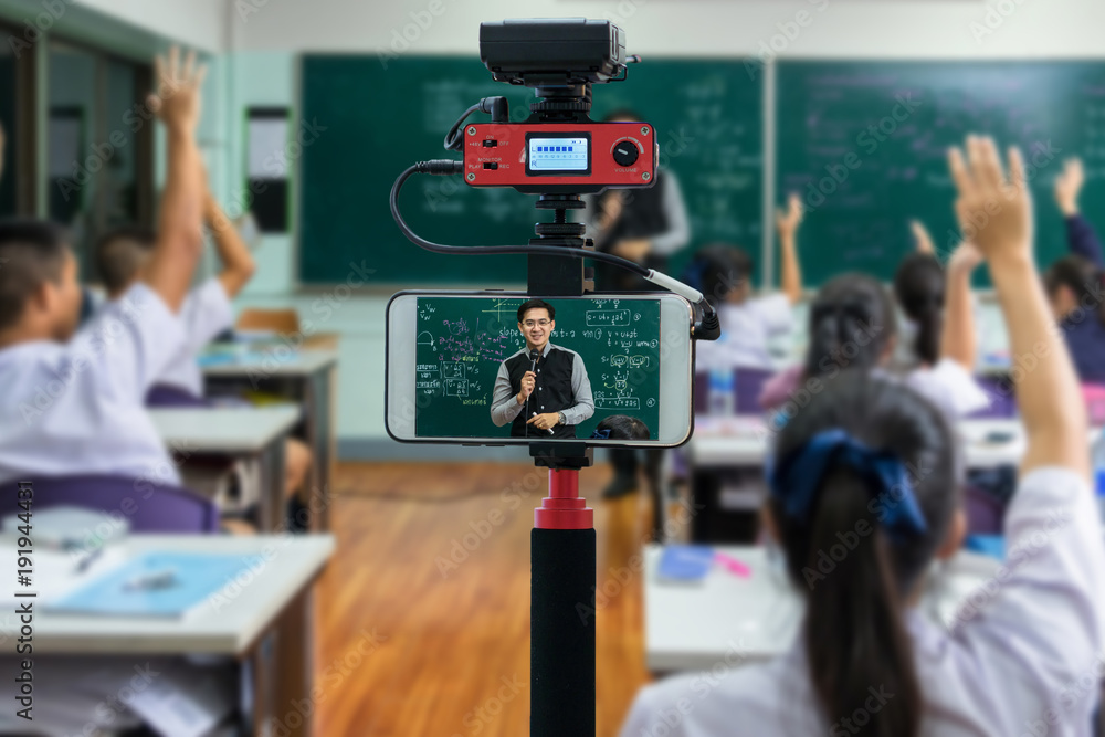 Closeup smart mobile phone taking Live of Asian teacher Giving Lesson ...
