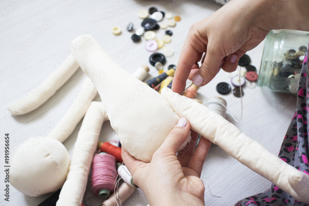 girl sews doll clothes, top view, sewing accessories top view ...