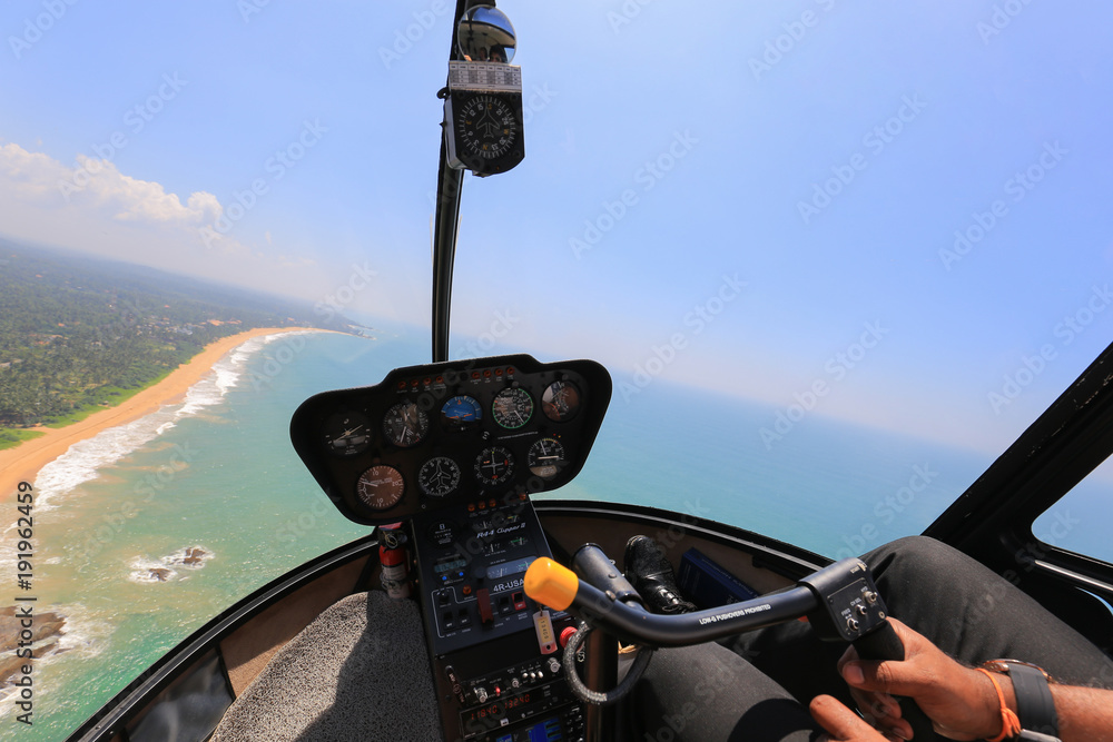 Helicopter Robinson R44 cockpit inside view. Helicopter flies over the ...