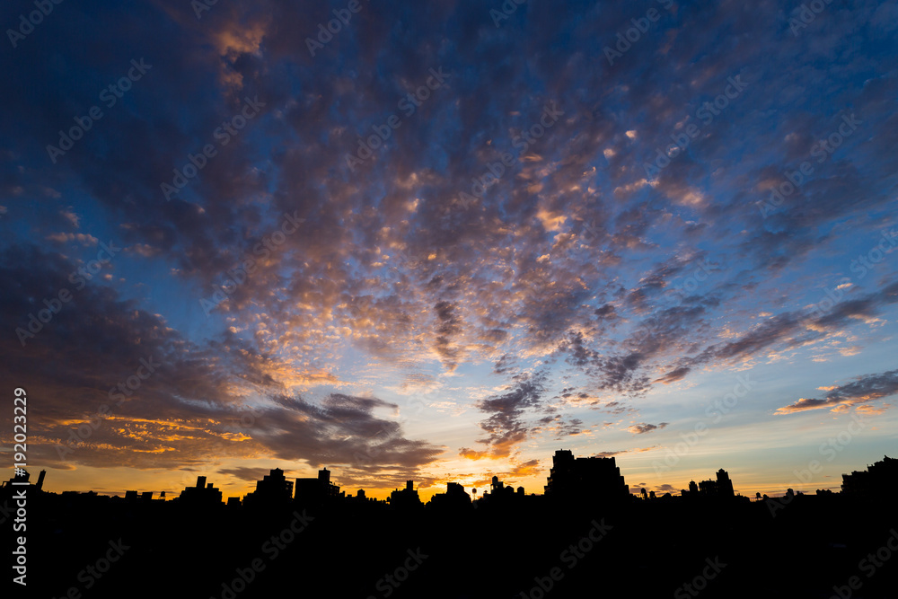 Sunset over rooftops and water towers in a city Stock Photo | Adobe Stock