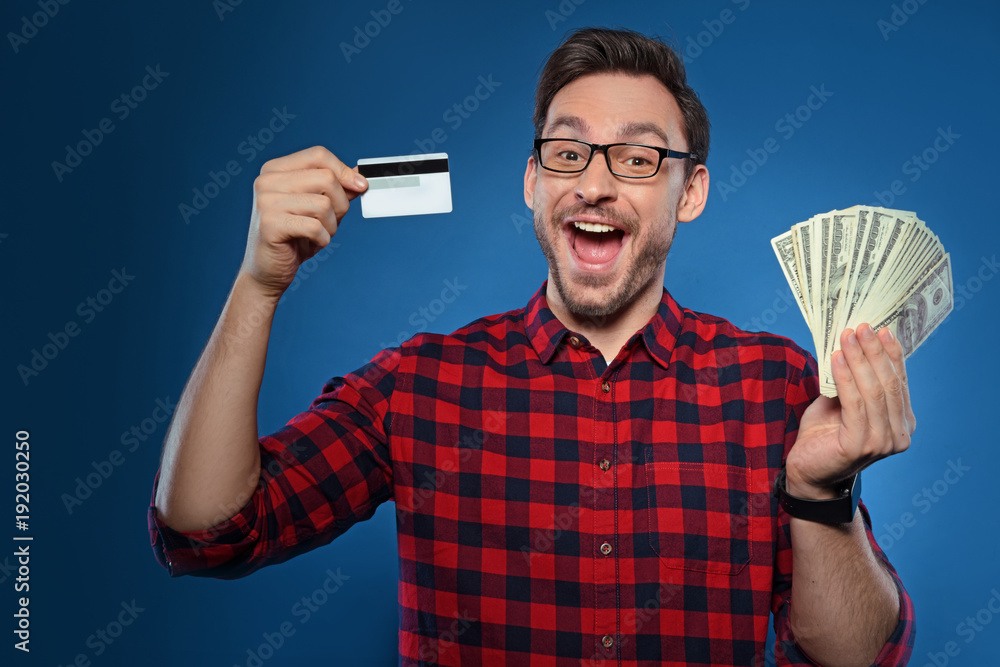 Handsome bearded man in red shirt and glasses holding stack of money ...