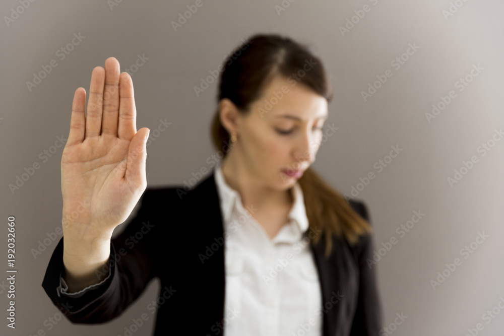 Woman in business suit showing her palm, body language, say NO at work ...