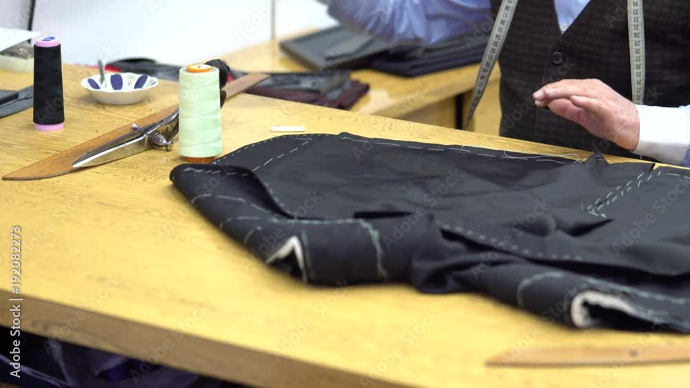 motion of a hand of a tailor who sews with a needle and thread by hand ...