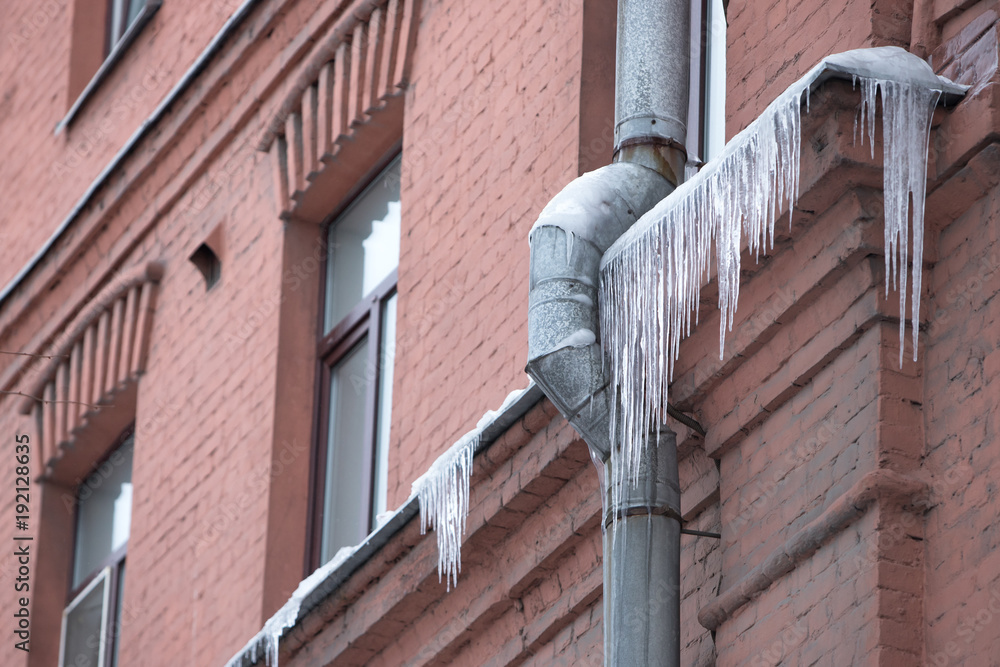 Window sill covered with big icicles, horizontal/ Ice stalactite ...