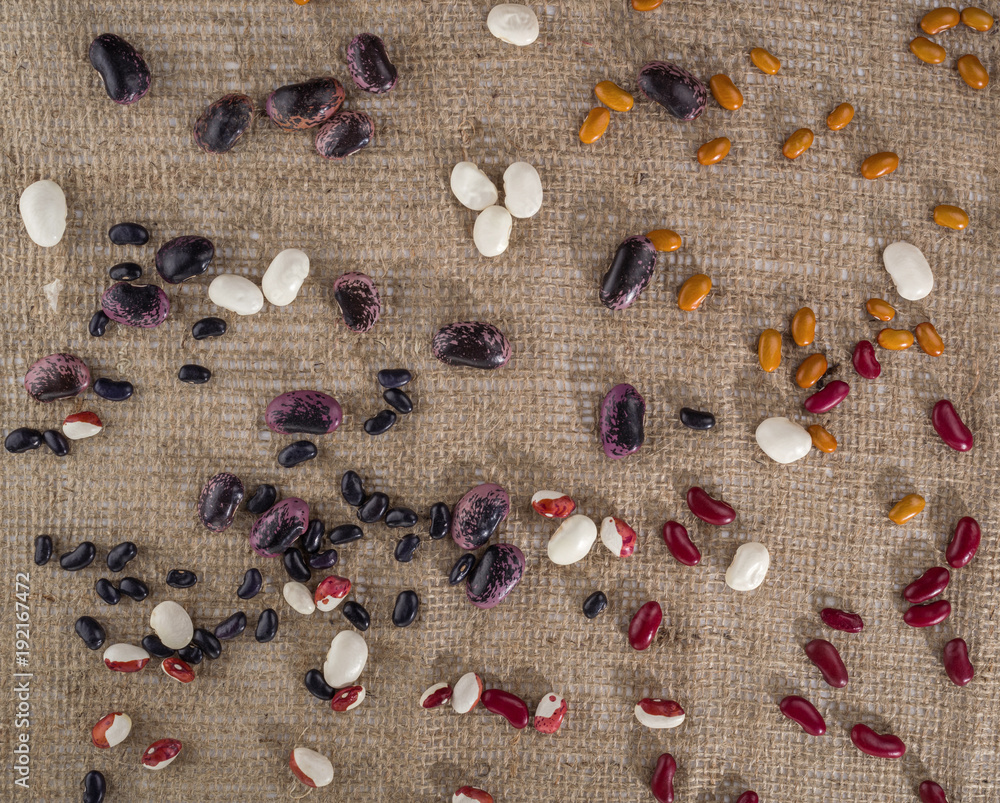 Different varieties of beans on the texture background of coarse cloth ...