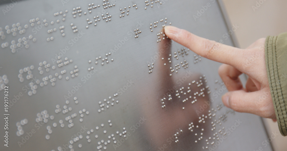 Blind reading on Braille at outdoor directory Stock Photo | Adobe Stock
