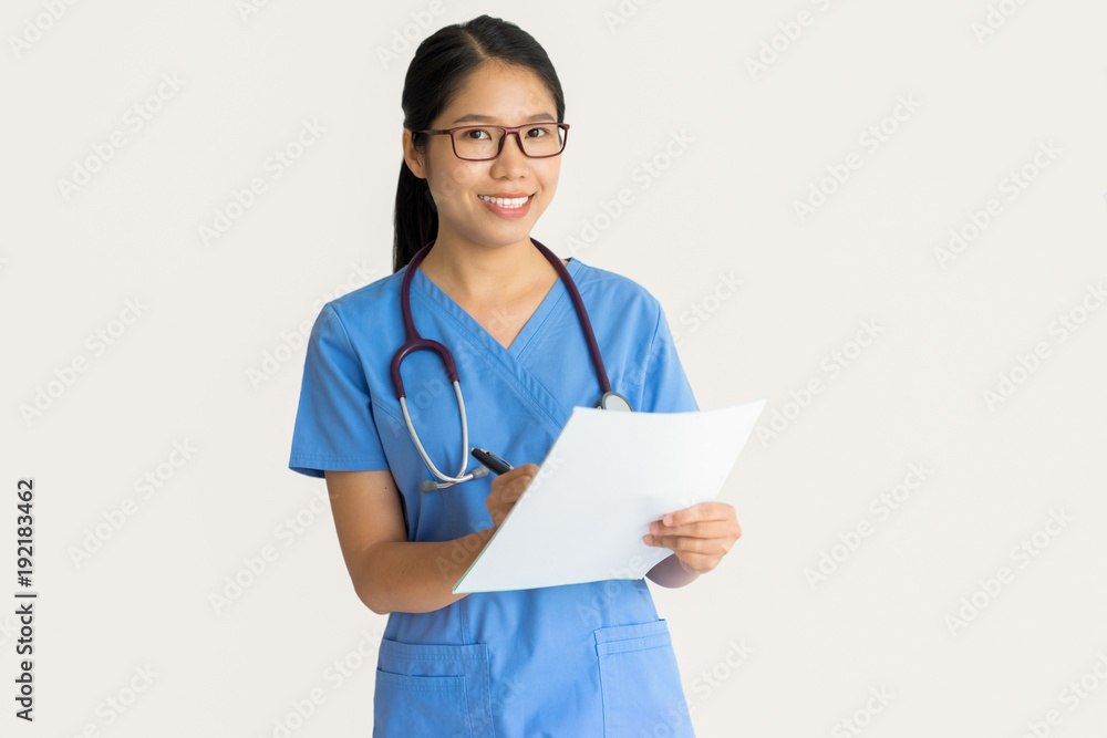Cheerful medical intern making notes on paper Stock Photo | Adobe Stock