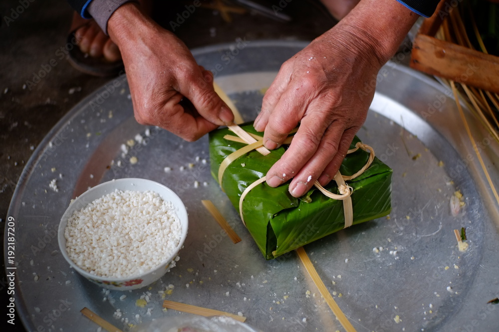 Packing Banh Chung (sticky rice cake), this is a traditional Vietnamese ...
