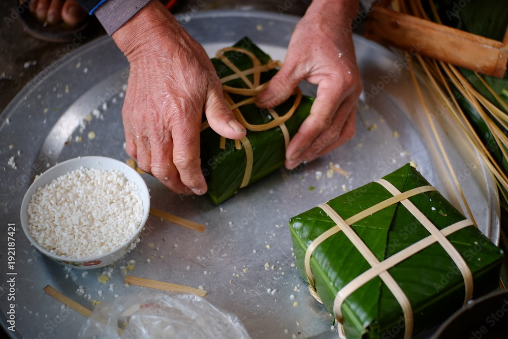 Packing Banh Chung (sticky rice cake), this is a traditional Vietnamese ...