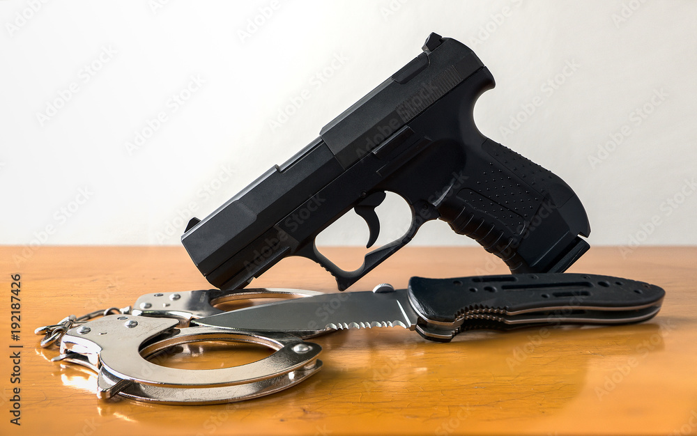 Tactical gear set of 9mm Pistol gun knift handcuff and clock on wooden ...