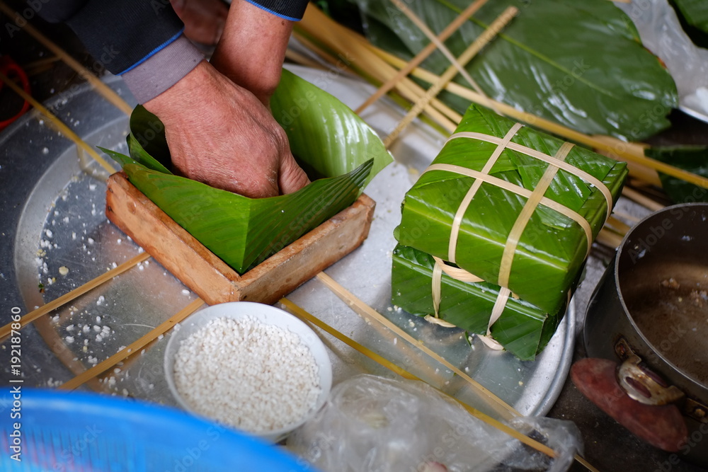 Packing Banh Chung (sticky rice cake), this is a traditional Vietnamese ...