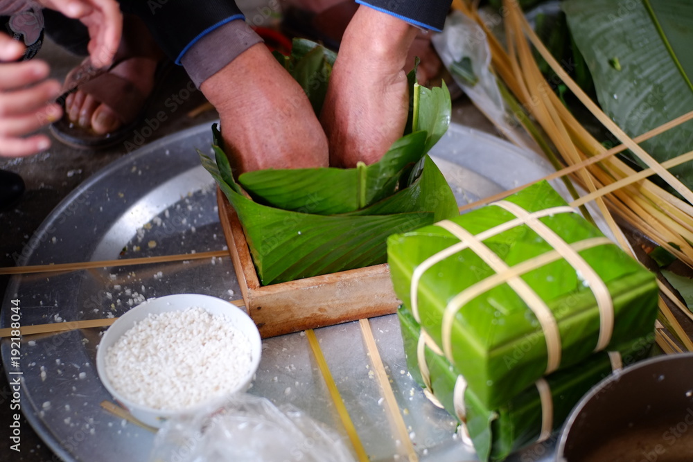 Packing Banh Chung (sticky rice cake), this is a traditional Vietnamese ...
