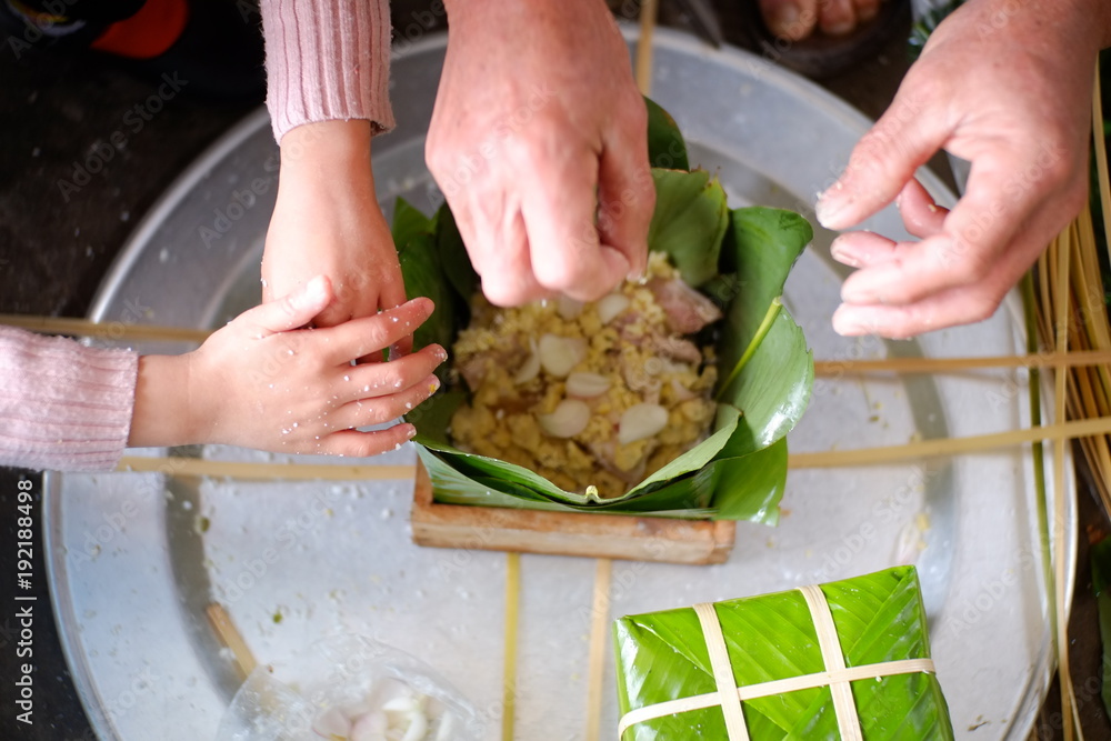 Packing Banh Chung (sticky rice cake), this is a traditional Vietnamese ...