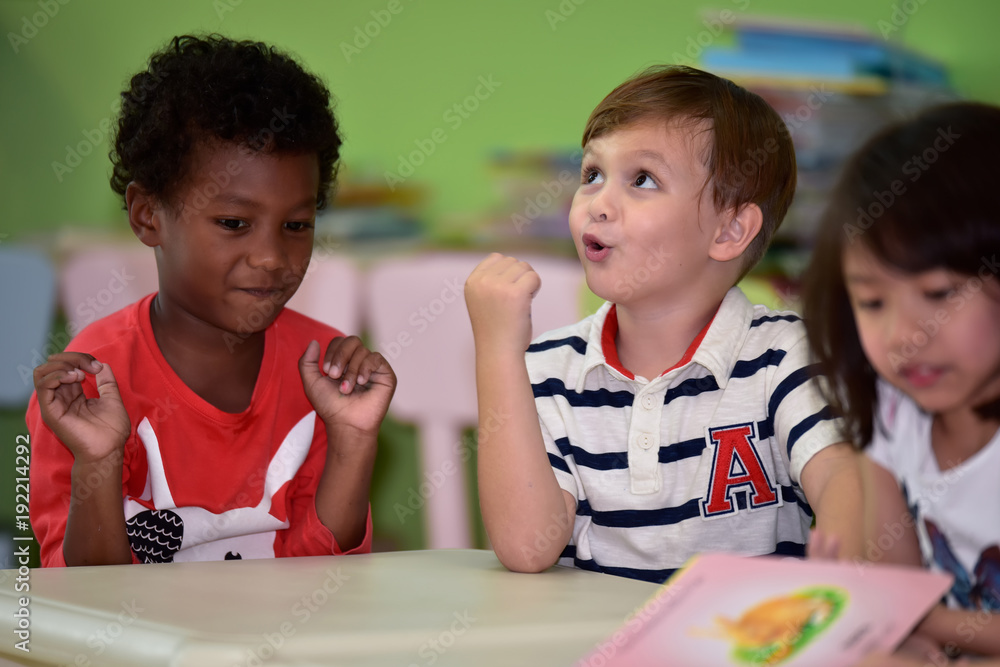 children having fun on learning in an international school library ...