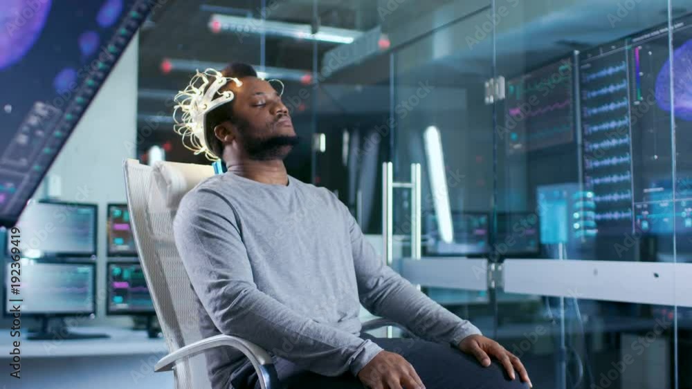 In Laboratory Man Wearing Brainwave Scanning Headset Sits in a Chair ...