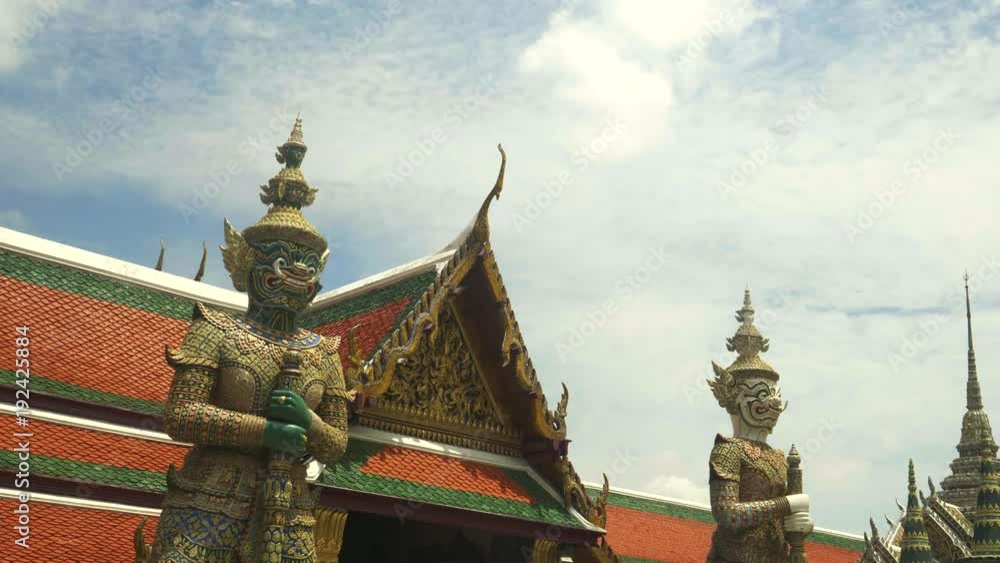 close up of a pair of giant demon statues at the temple of the emerald ...